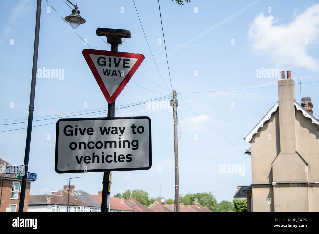 UK road sign with a triangular "Give Way" warning above a "Give way to ...