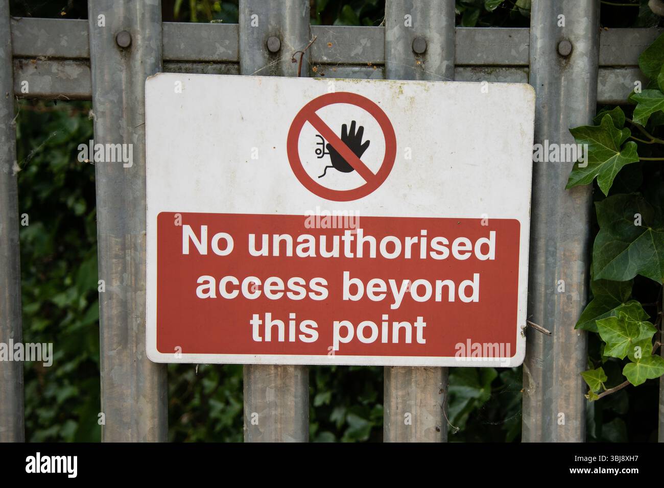“No unauthorised access beyond this point” sign on a rural path with ...