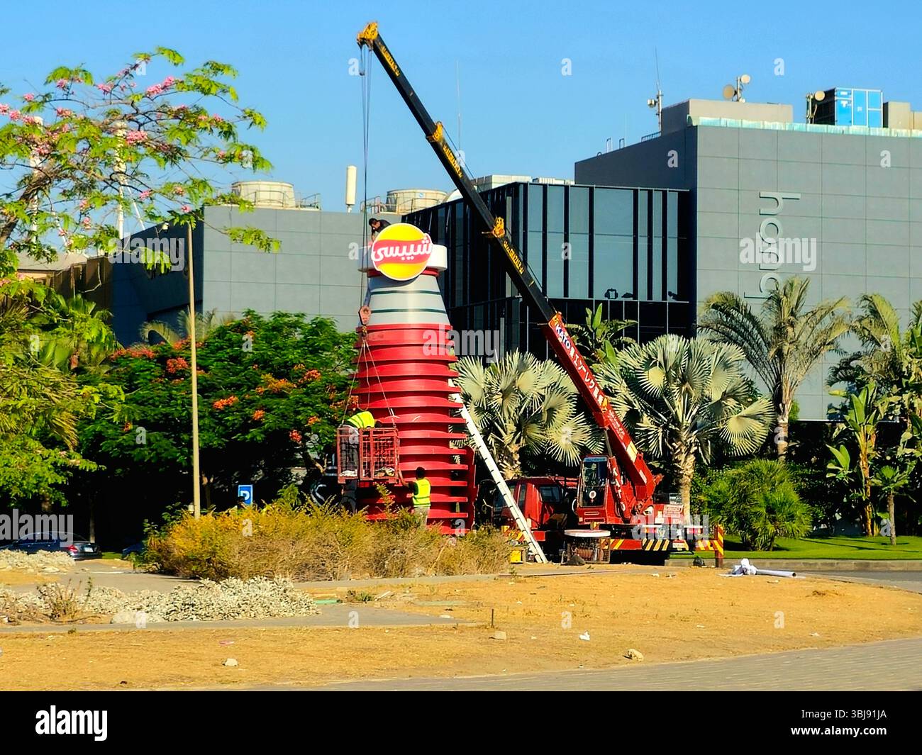 Cairo, Egypt, June 11 2025: A mobile crane installing Chipsy and Heinz ...