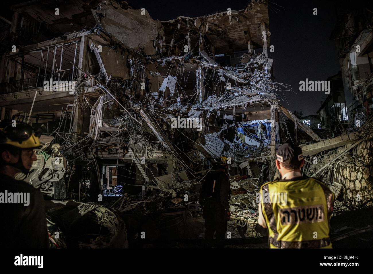 Israeli Home Front Command soldiers inspect a building that was ...