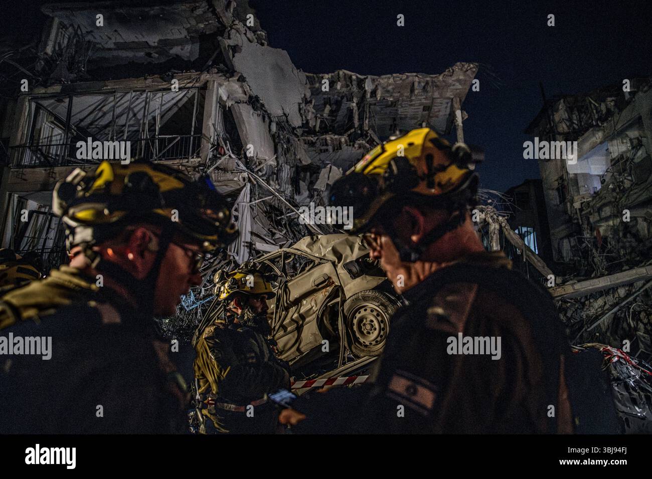 Israeli Home Front Command soldiers inspect a building that was ...