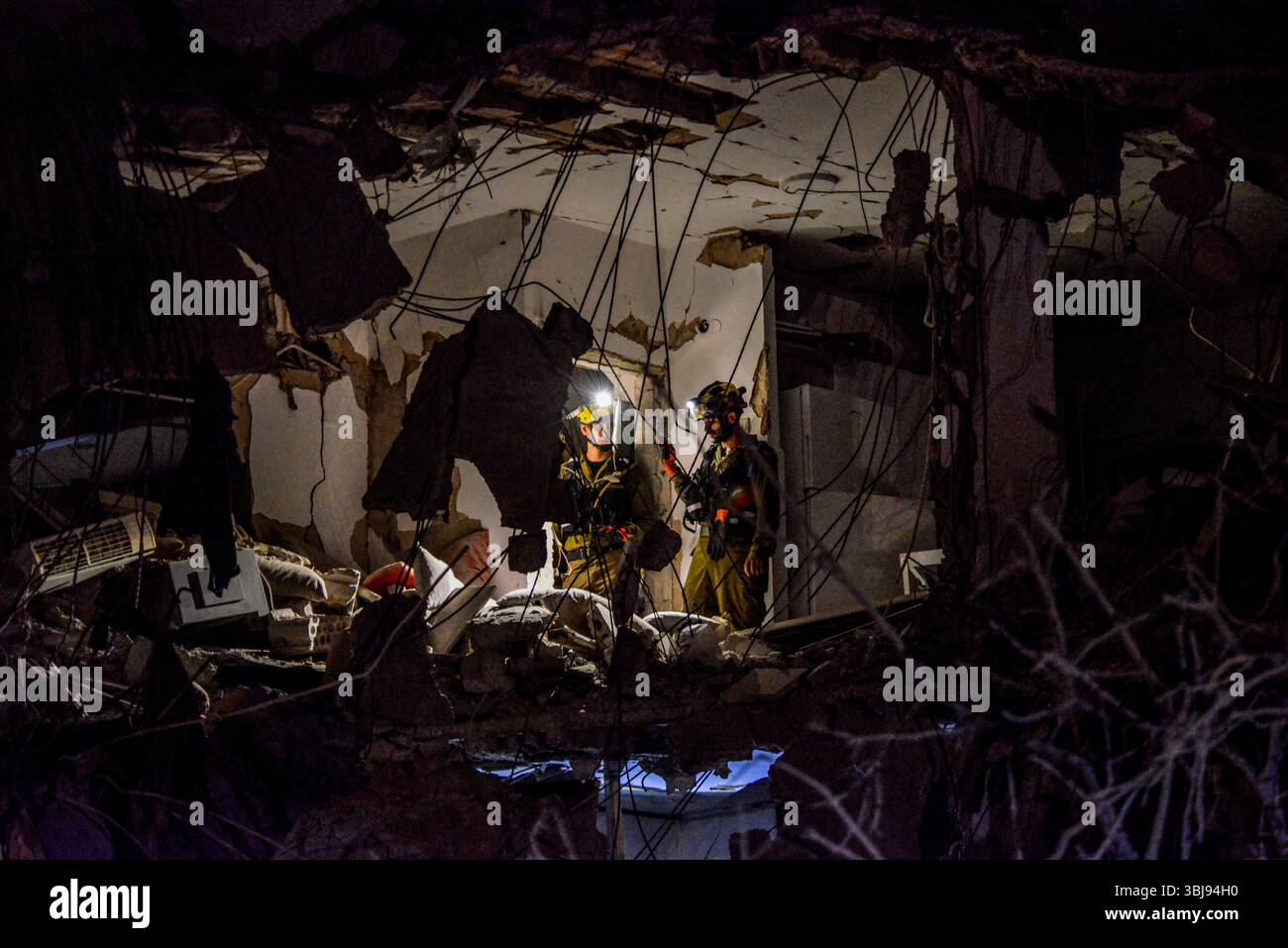 Israeli Home Front Command soldiers inspect a building that was ...
