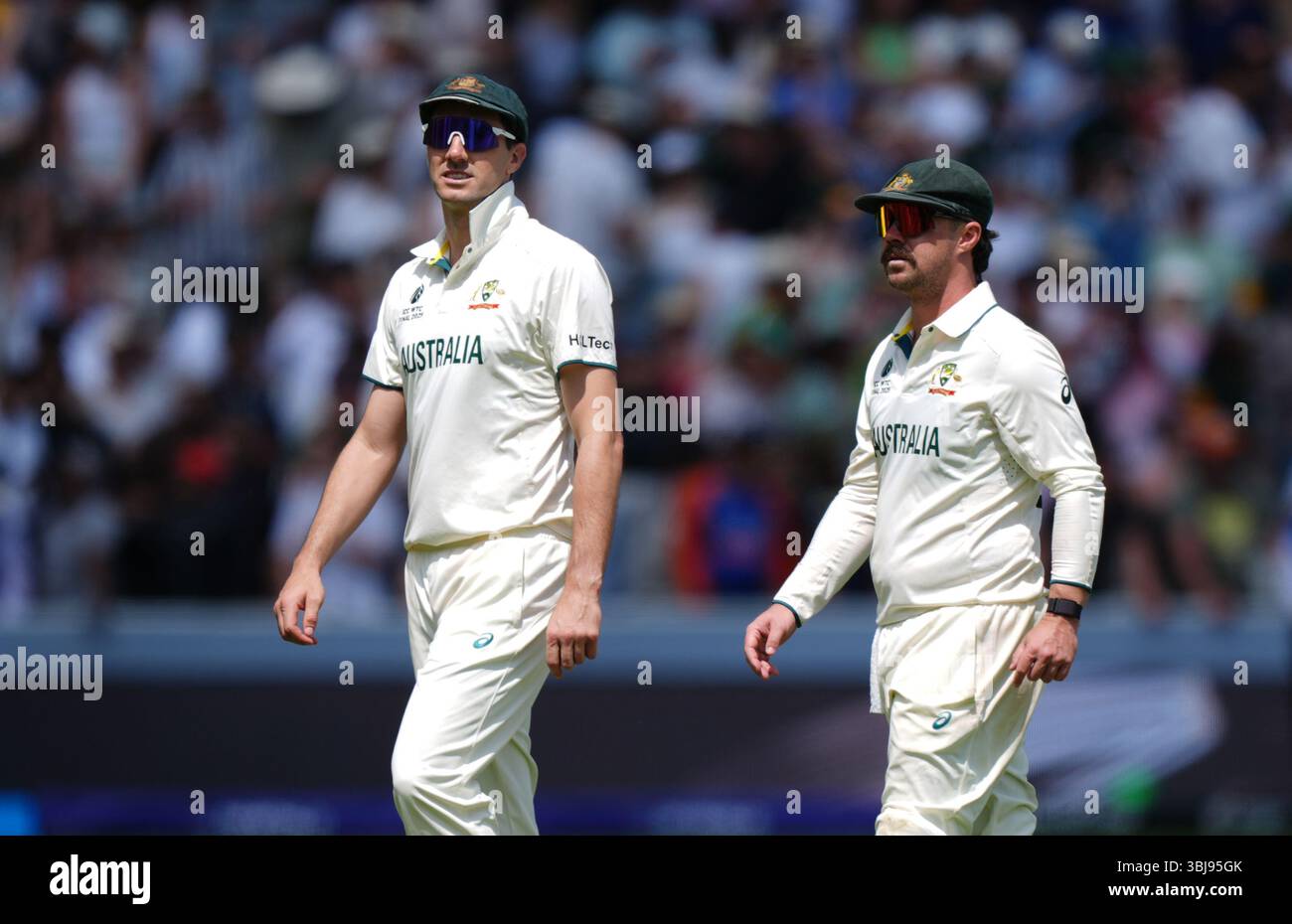 Australia’s Pat Cummins (left) and Travis Head leave the field after ...
