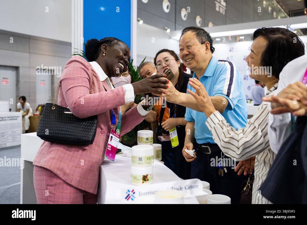 Beijing, China's Hunan Province. 13th June, 2025. An exhibitor (L ...