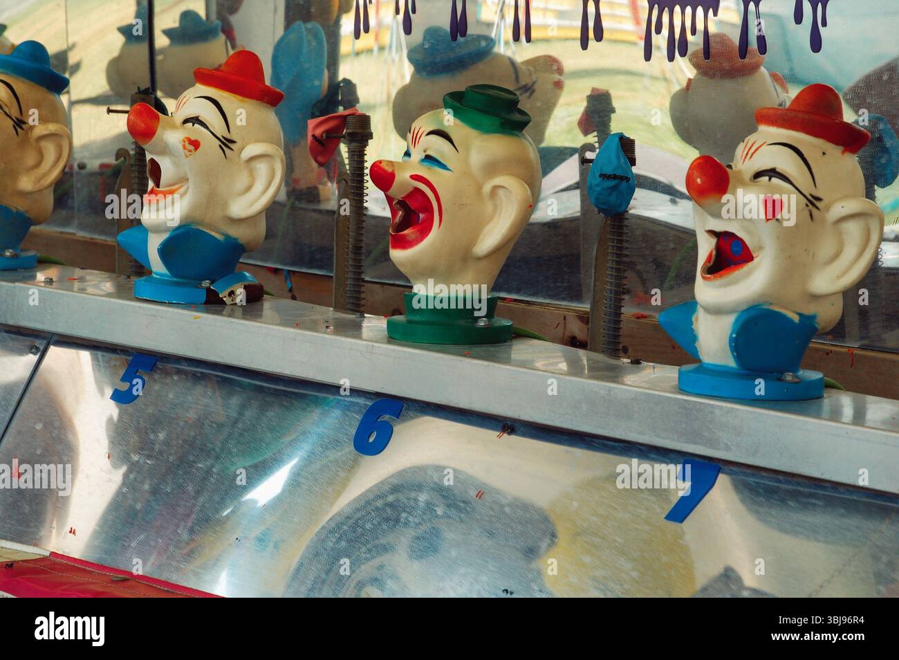 Clown heads on a carnival water pistol game Stock Photo - Alamy