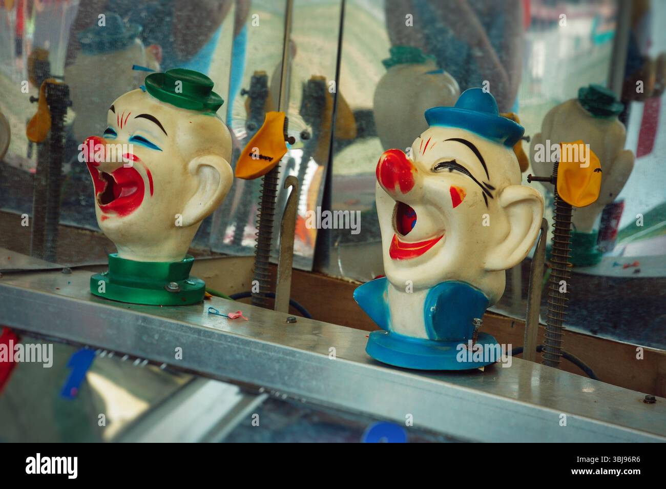 Clown heads on a carnival water pistol game Stock Photo - Alamy