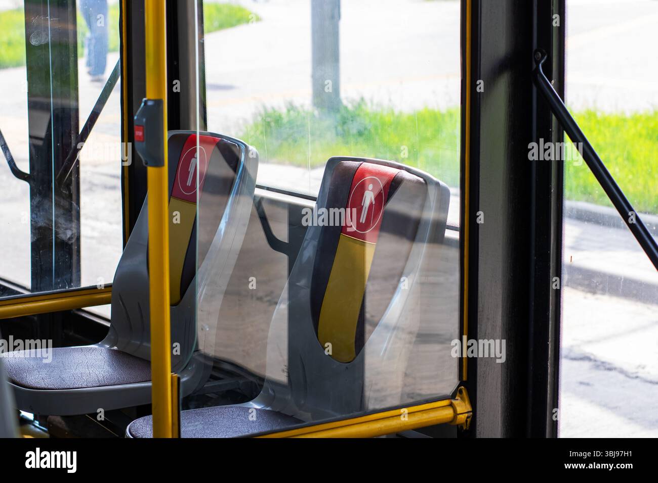 A large bus that features a prominent red button marked with the word ...