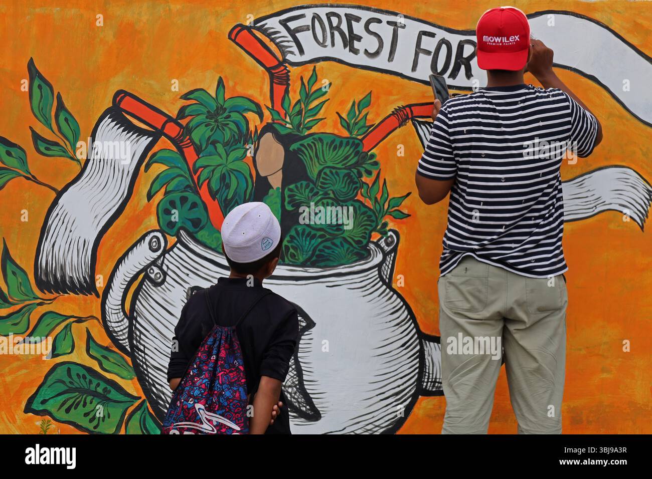 Banda Aceh, Aceh, Indonesia. 14th June, 2025. An artist paints a mural ...