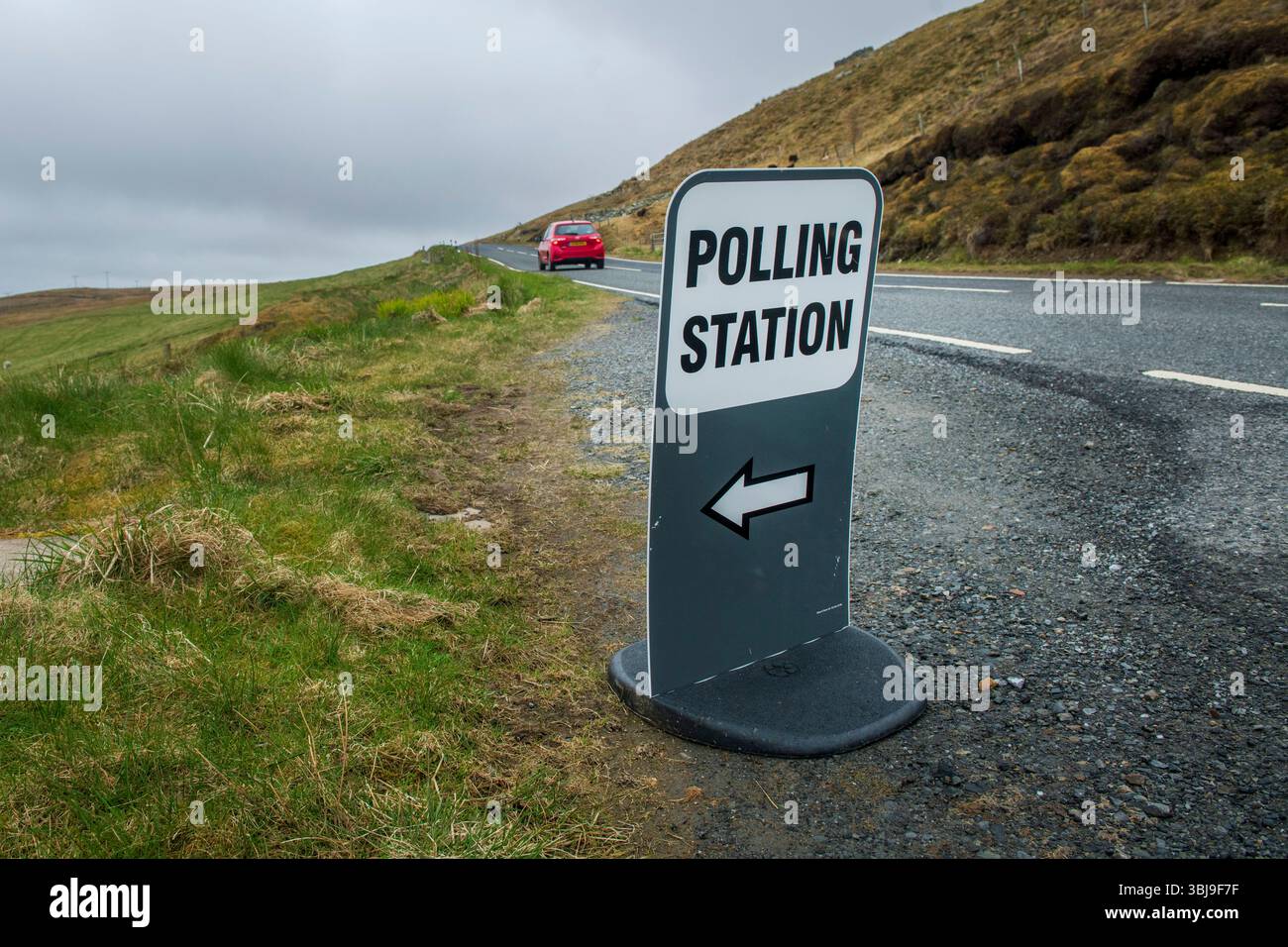 A polling station sign stands outside a rural village hall in Shetland ...