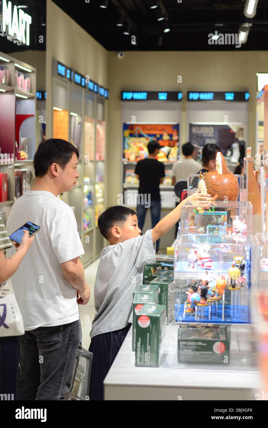 Jiangmen,Guangdong,China.14 June,2025.Customers selecting Labubu Collectibles at Pop Mart Store ...