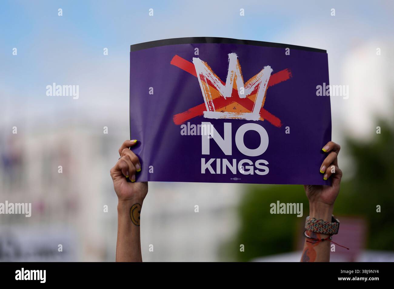 A demonstrator holds a sign during a "No Kings" protest, Saturday, June ...