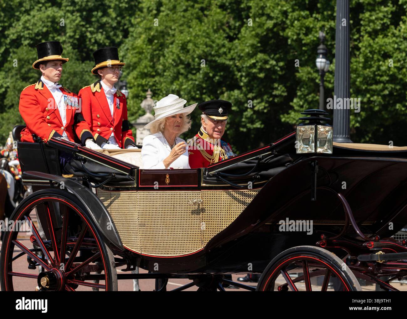King Charles and Queen Camilla riding in an open top carriage for ...