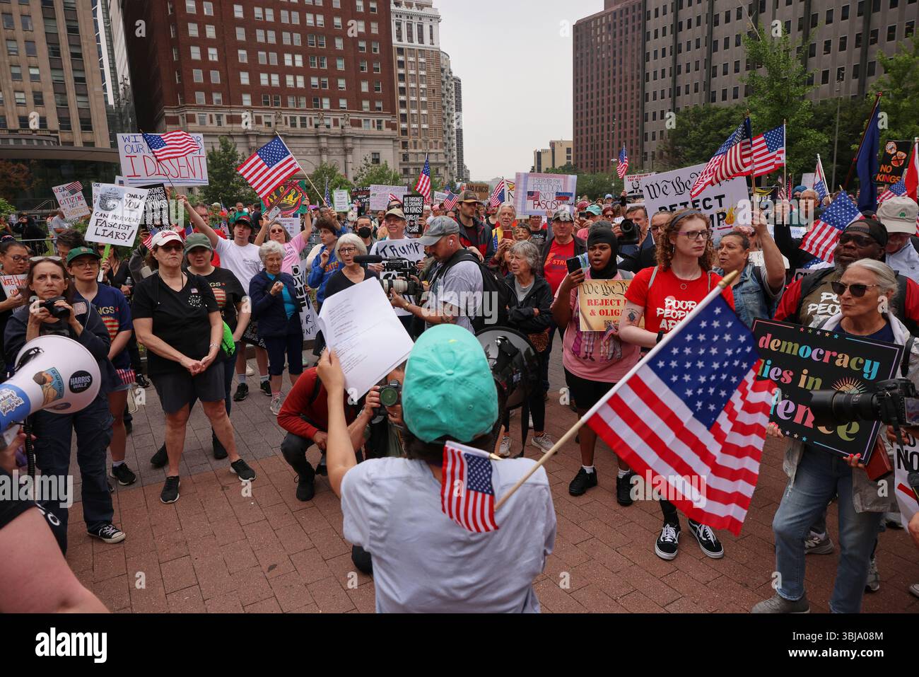 An organizer leads protestors in a chant during the "No Kings" protest ...