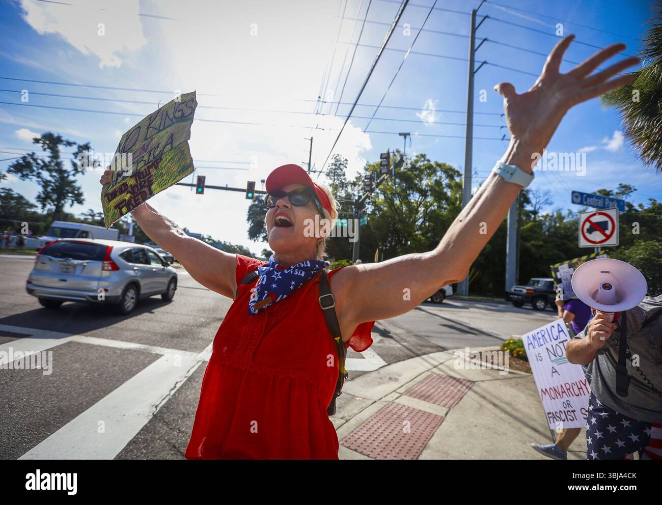 Kimberly Tichenor , 58, of Palm Harbor sings while waving a sign during ...