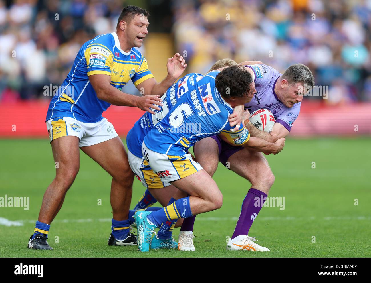 Warrington Wolves' Lachlan Fitzgibbon (right) is tackled by Leeds ...