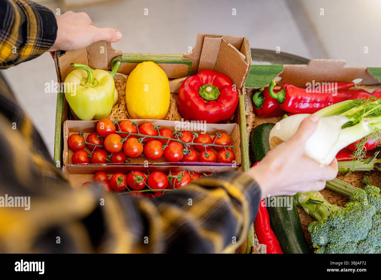 Unpacking fresh organic produce from delivery box top view Stock Photo ...