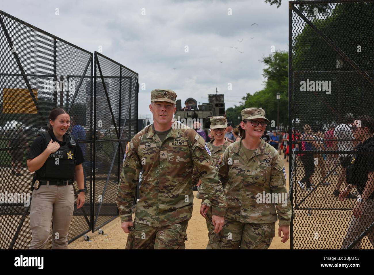 Members of the military walk on the National Mall ahead of a military ...