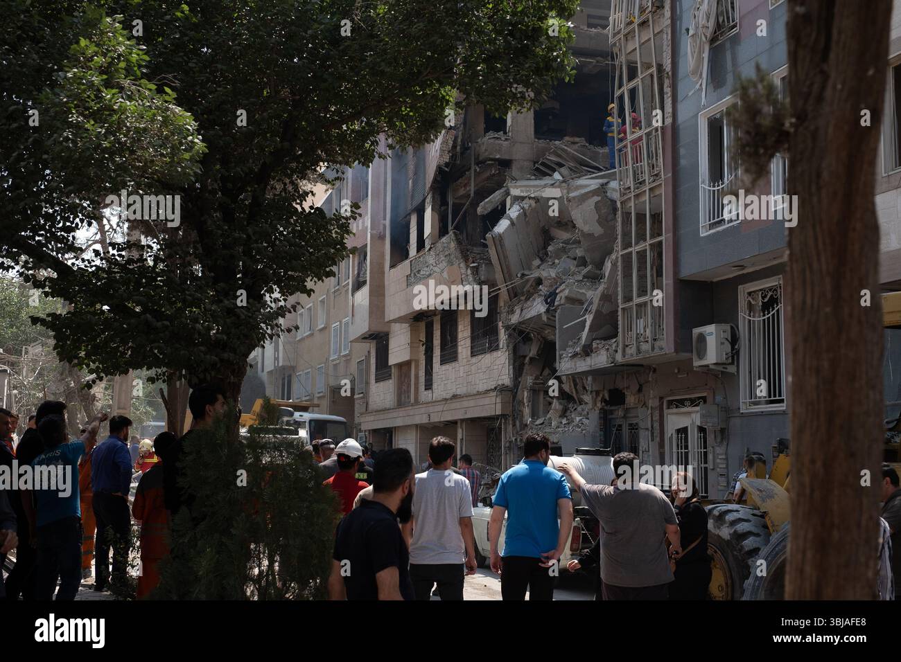 Tehran, Iran. 12th June, 2025. Iranians look over damage from Israeli ...