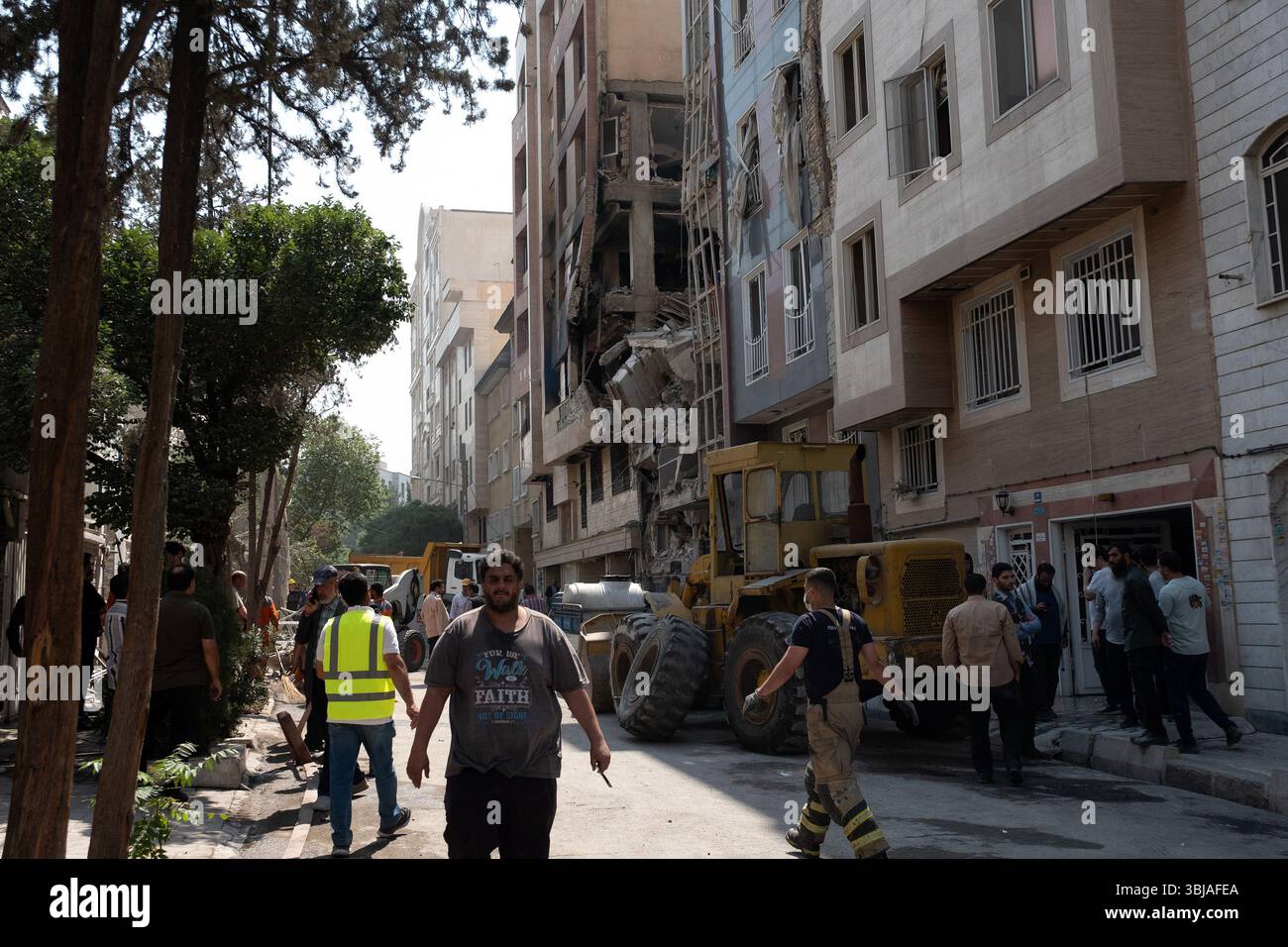 Tehran, Iran. 12th June, 2025. Iranians look over damage from Israeli ...
