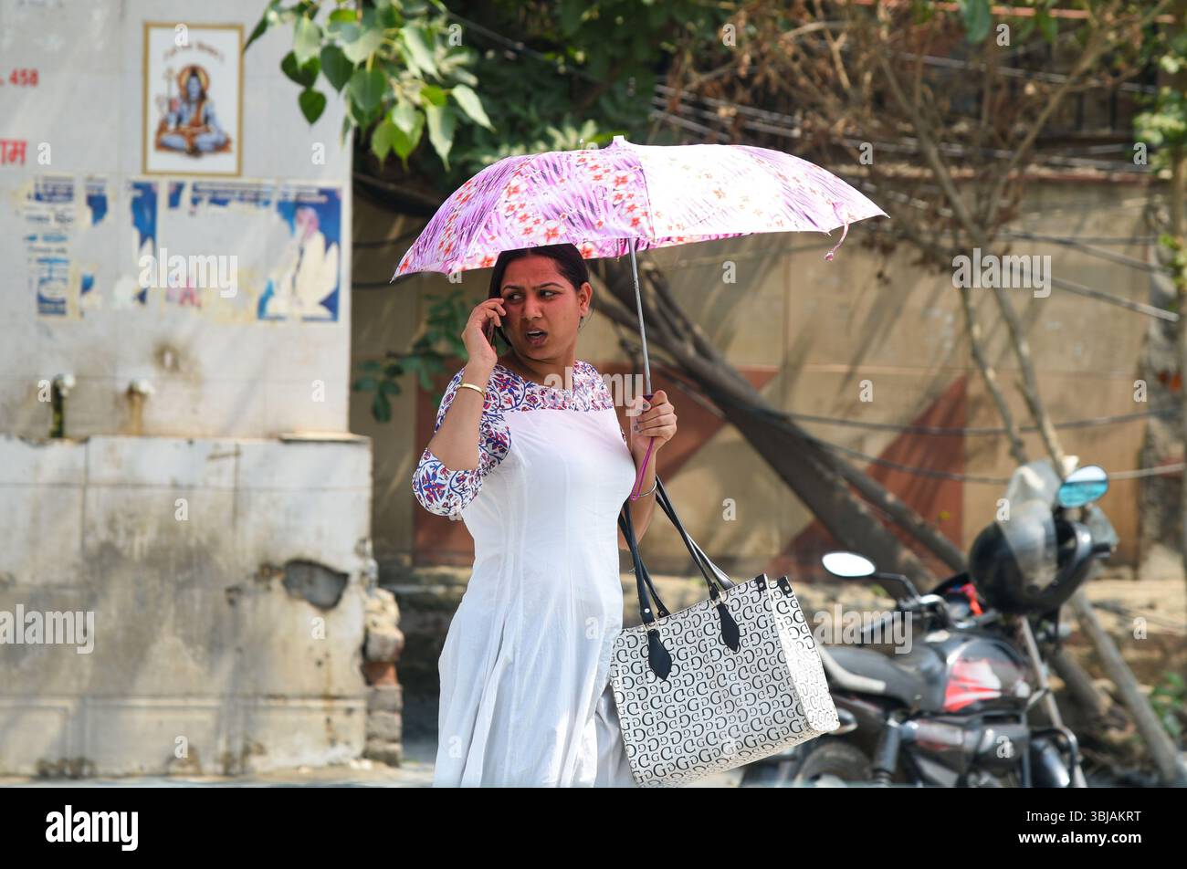 GURGURAM, INDIA - JUNE 14: People seen covering their head and face ...