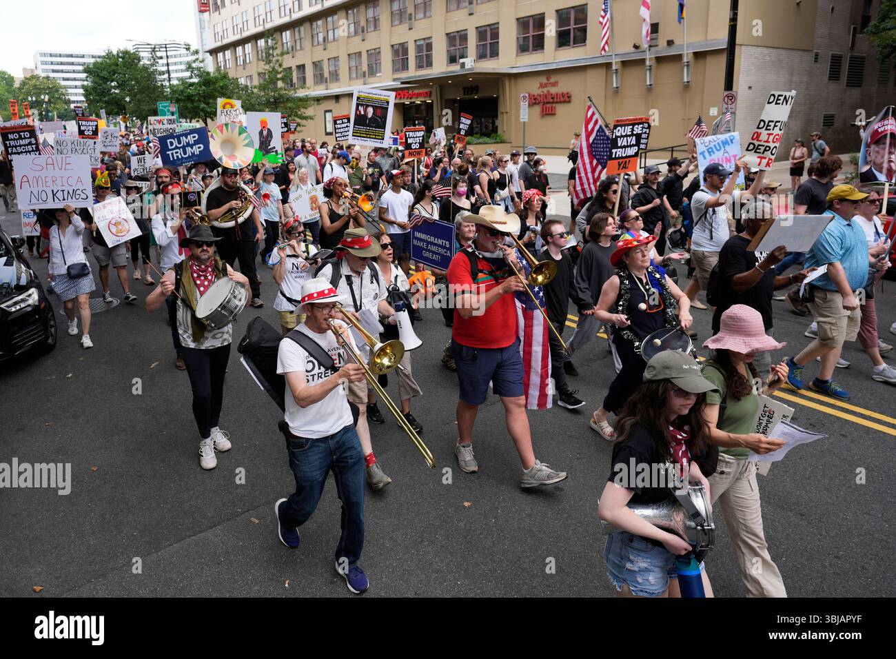 Demonstrators play instruments as they march during a protest taking ...