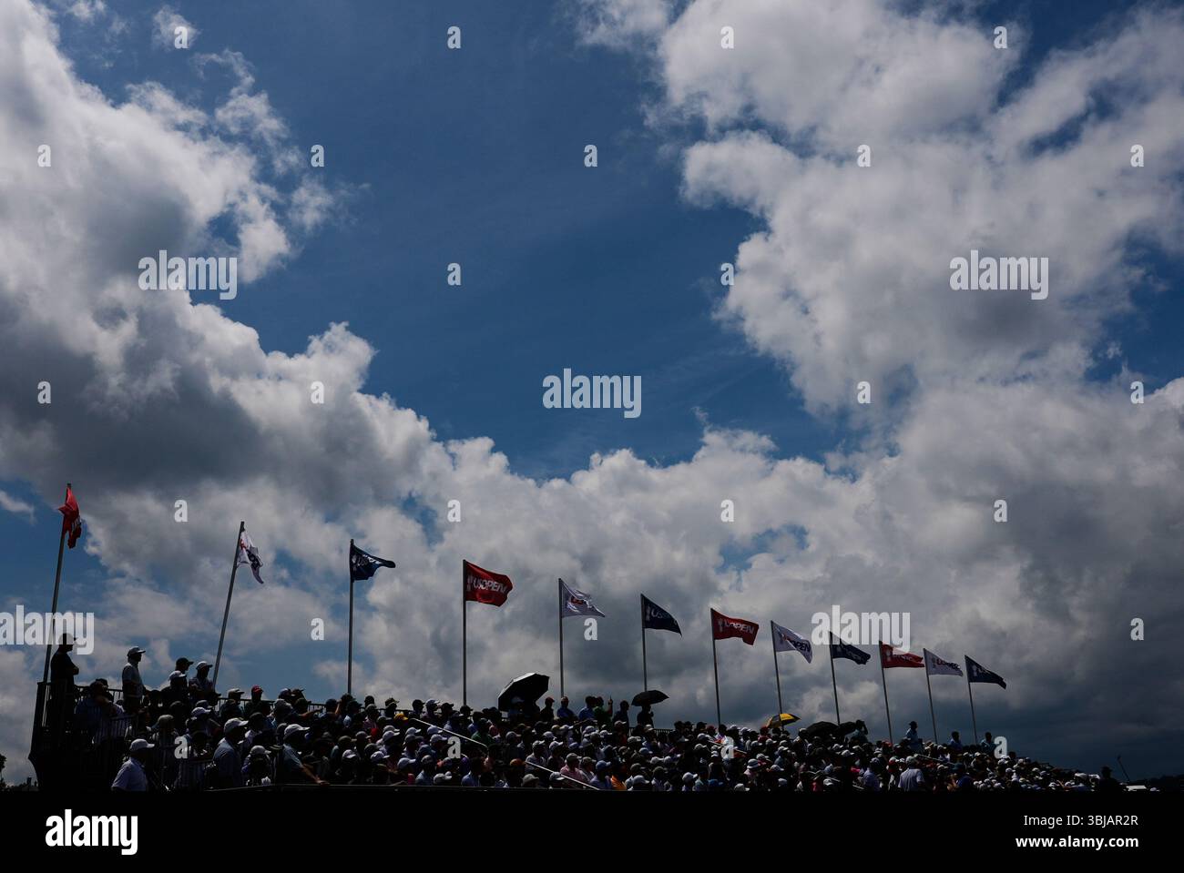 Fans sit in the grandstand on the eighth green during the third round ...