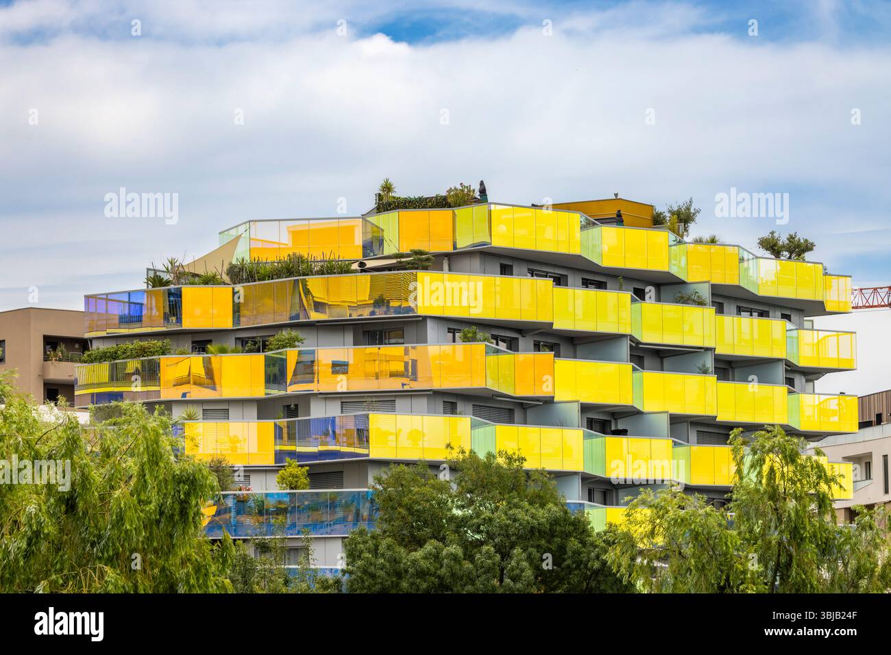 Modern architecture featuring a building with vibrant yellow and green ...