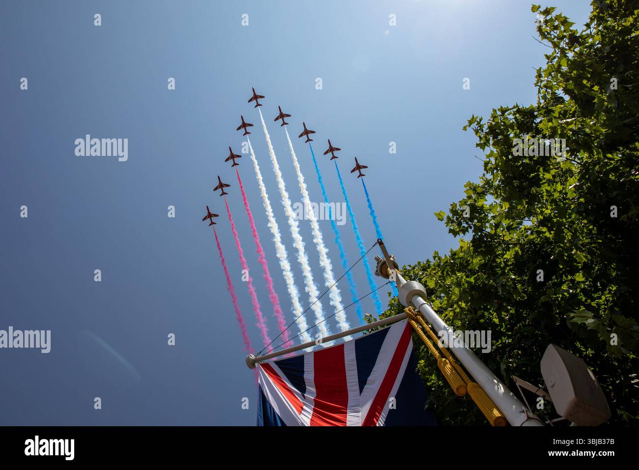 London, UK, 14th June 2025. The Red Arrows fly past a Union flag at the ...