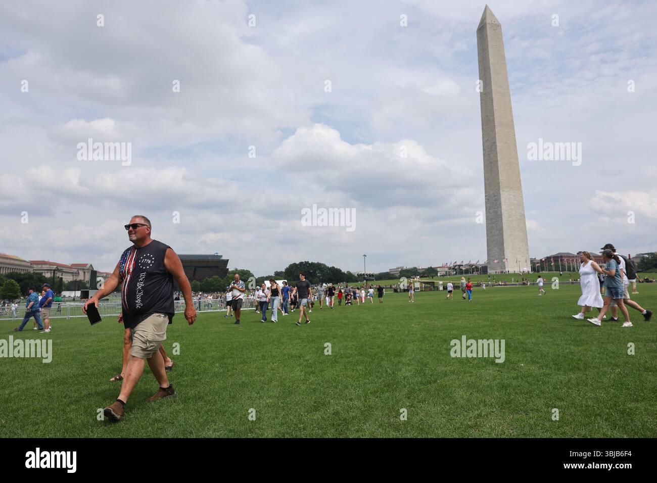 Spectators walk on the National Mall ahead of a military parade ...