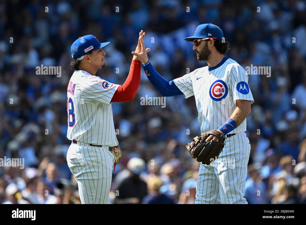 Chicago Cubs pitcher Daniel Palencia, left, high-fives shortstop Dansby ...