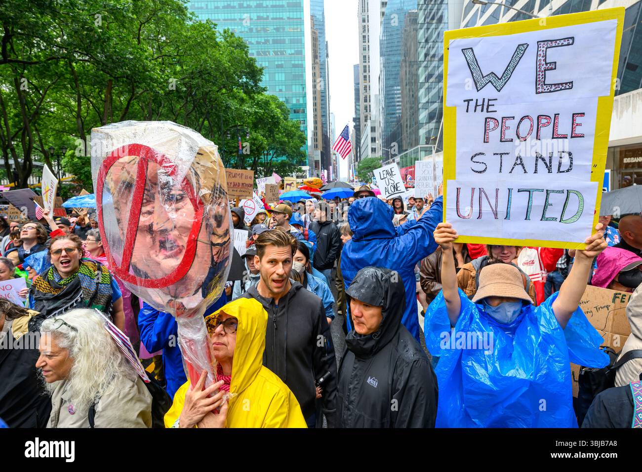 New York, USA. 14th June, 2025. People defy the rain and carry anti ...