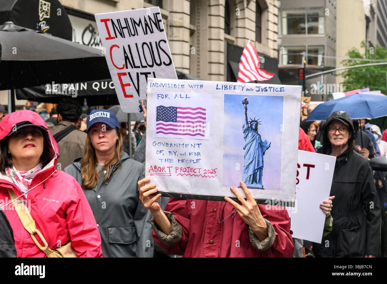 New York, USA. 14th June, 2025. People defy the rain and carry anti ...