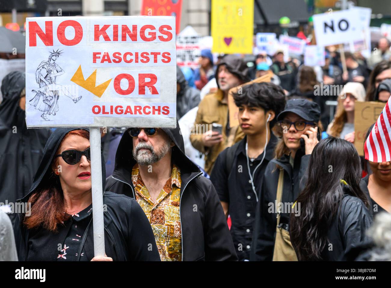 New York, USA. 14th June, 2025. People defy the rain and carry anti ...