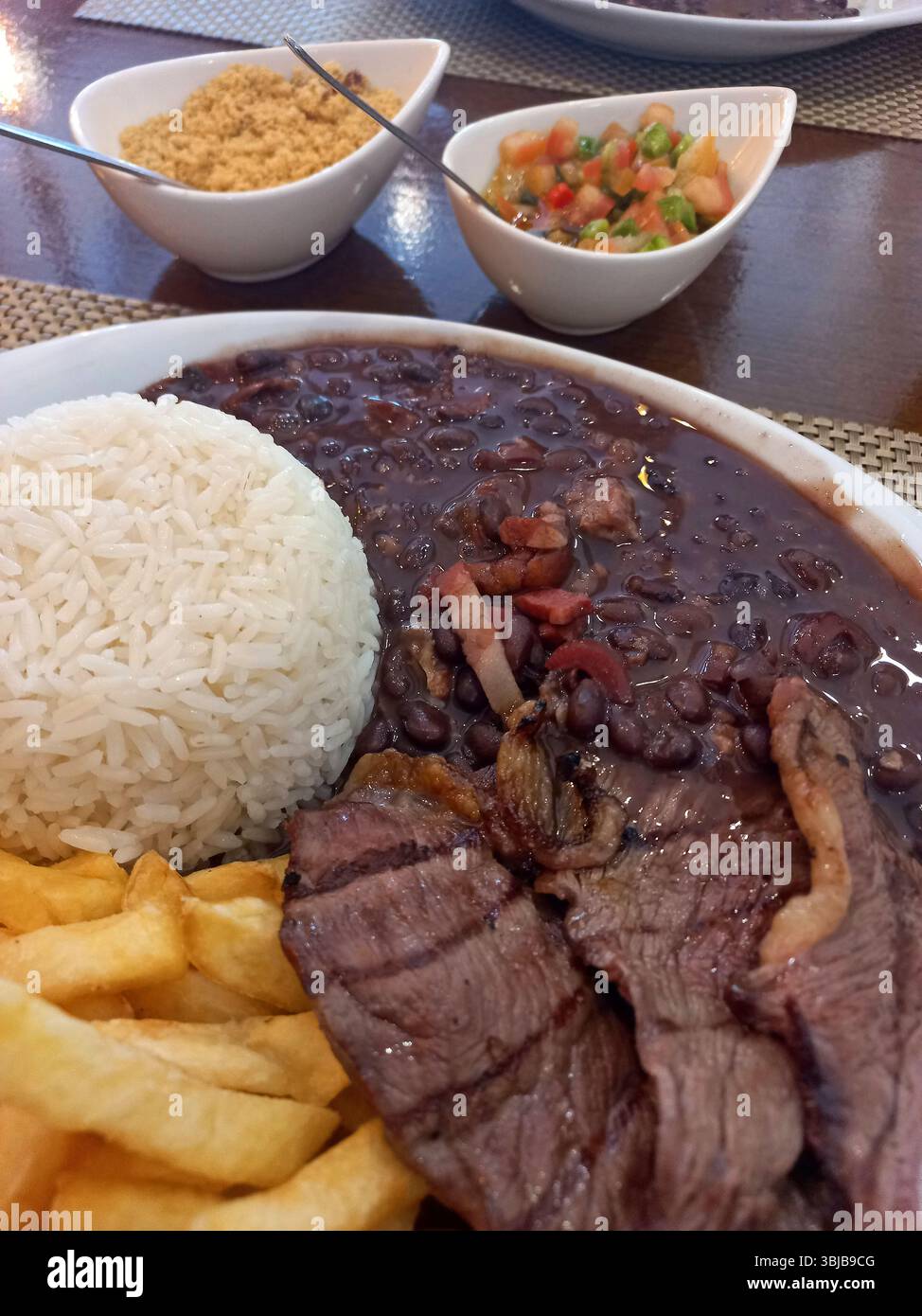 Typical Brazilian meal with white rice black beans grilled beef picanha ...