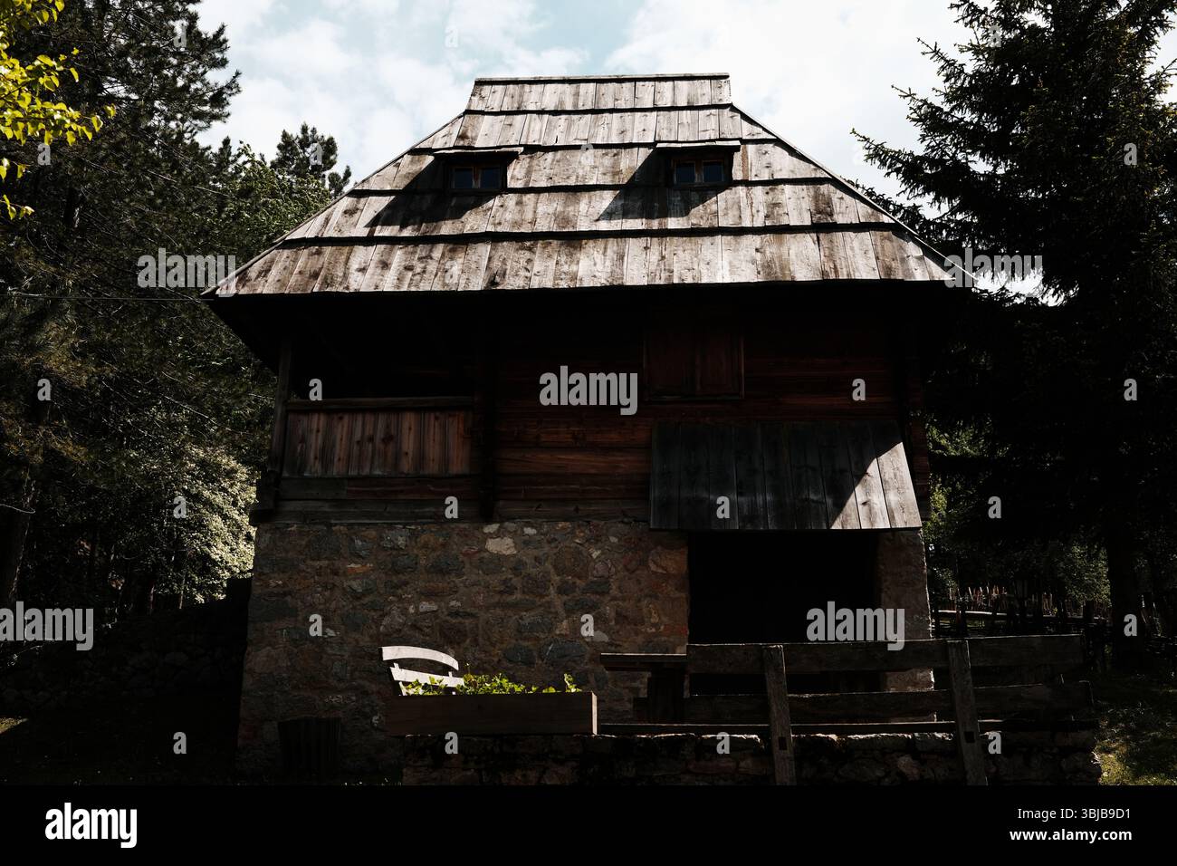 Traditional stone and wood village house in Staro Selo, Serbia. Open ...