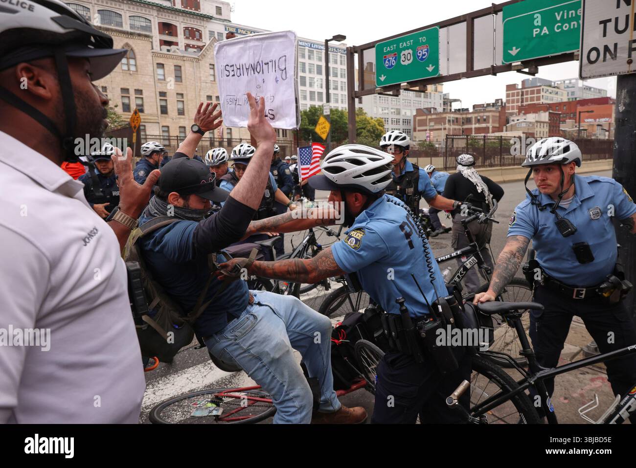 Philadelphia police officers confront protestors during a protest ...