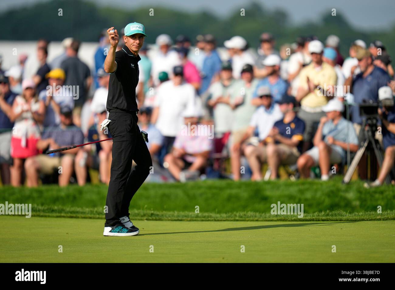 Carlos Ortiz, of Mexico, celebrates after making a putt on the 18th ...