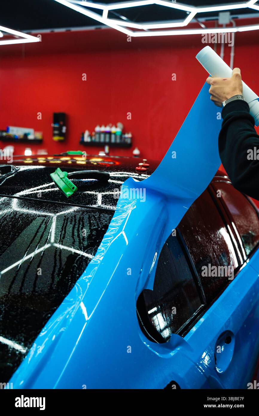 Protective film layering during PPF wrap detailing to protect the car ...