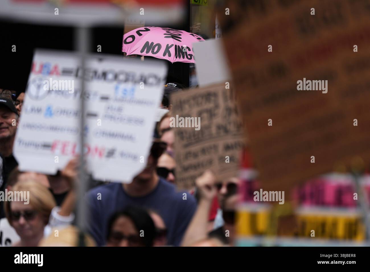 People take part in the "No Kings Day" protest, Saturday, June 14, 2025 ...