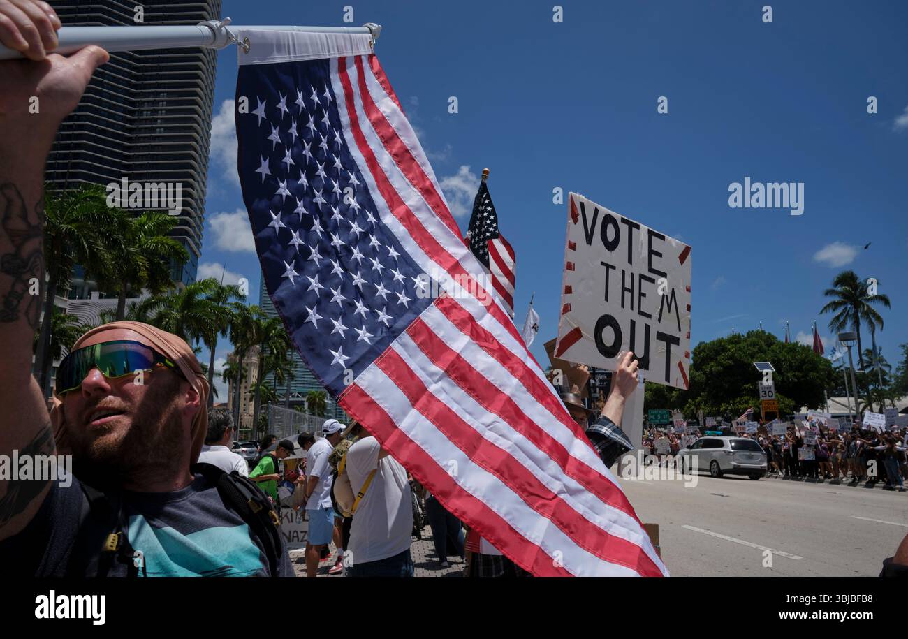 Miami, Florida, USA. 14th June, 2025. A man waves an upside-down US ...