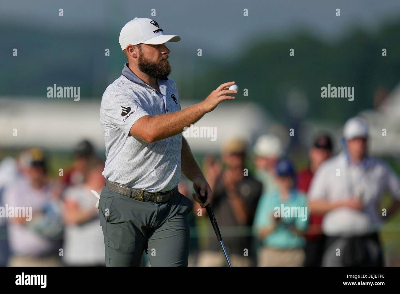 Tyrrell Hatton, of England, celebrates after making a putt on the 18th ...