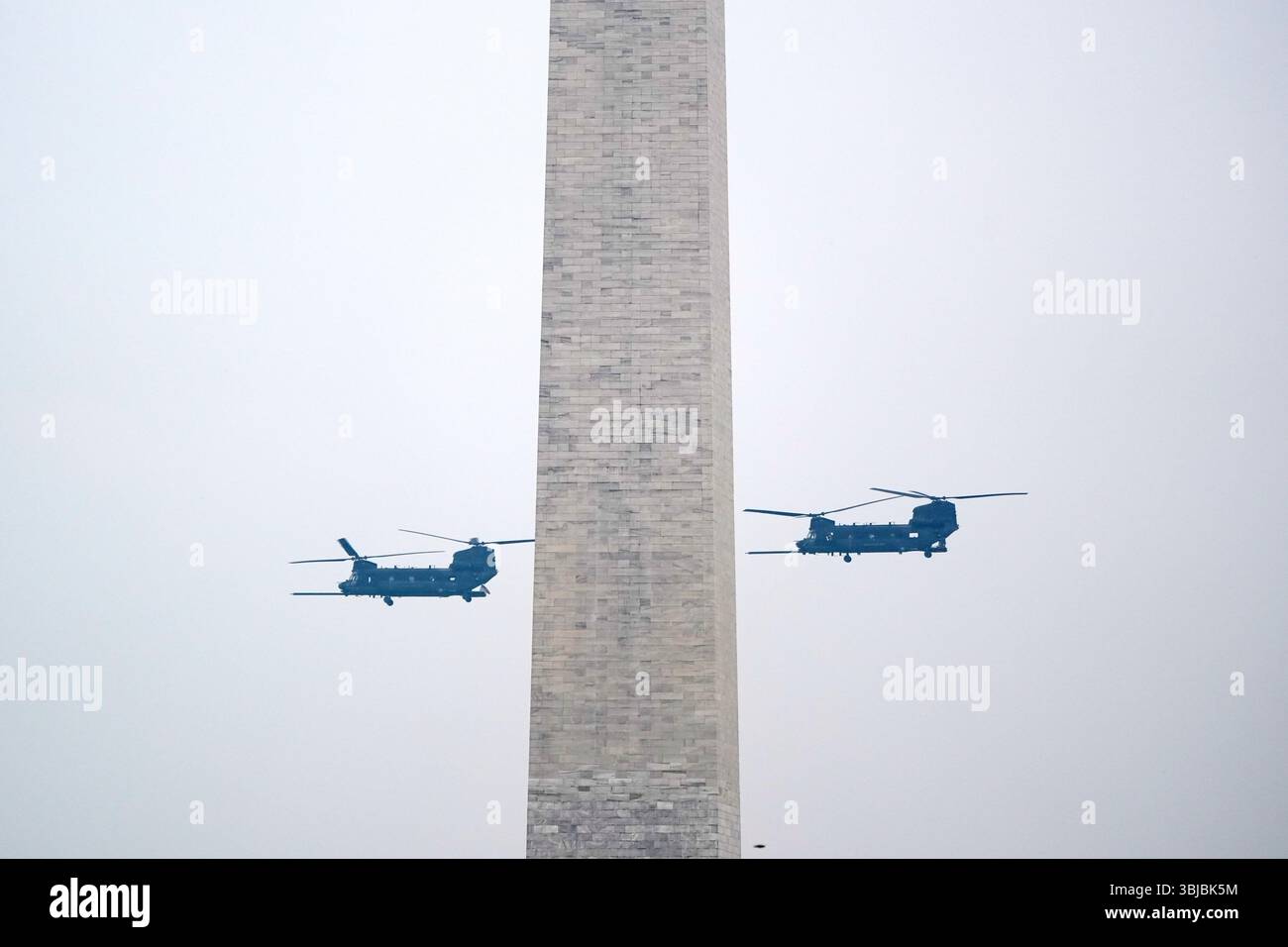 U.S. Army CH-47 Chinook helicopters perform a flyover during an event ...
