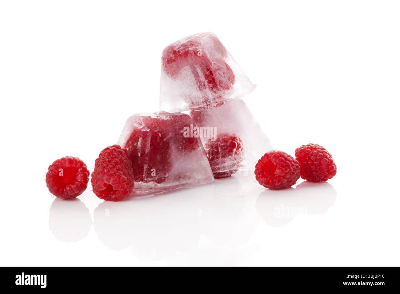 Ripe fresh raspberries frozen in ice cubes isolated on white background ...