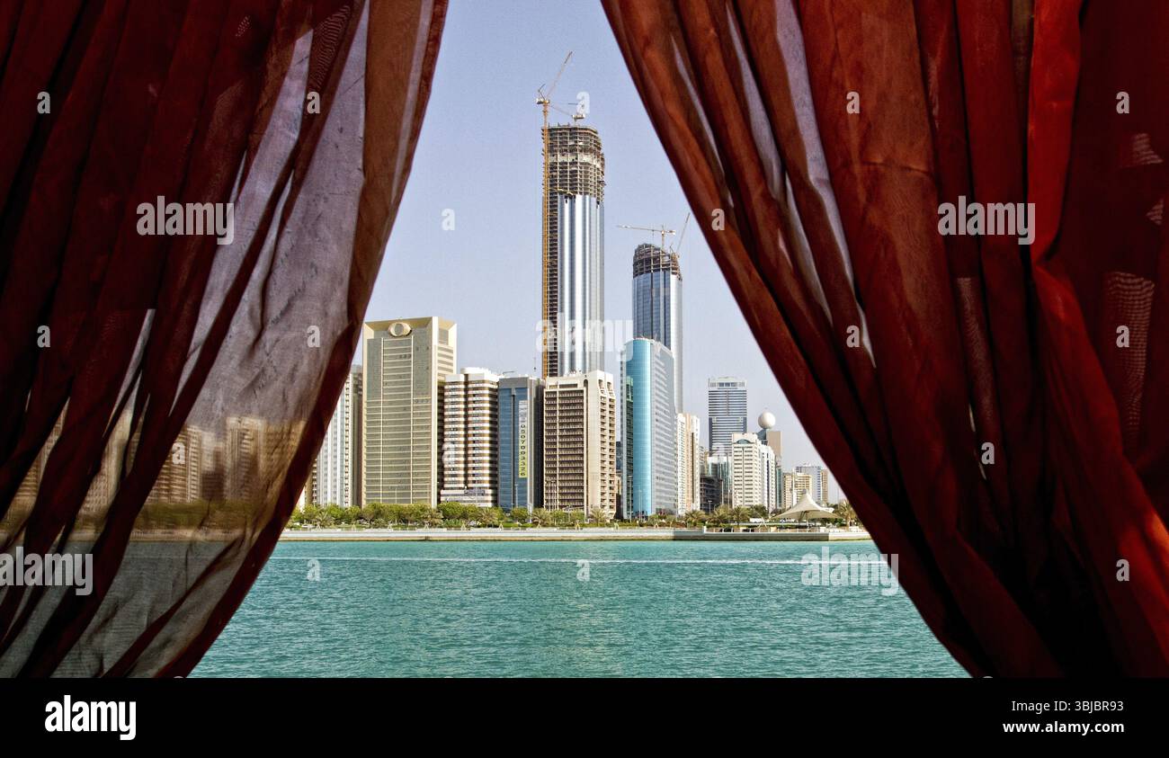 View through the window of the Abu Dhabi skyline on the Persian Gulf ...