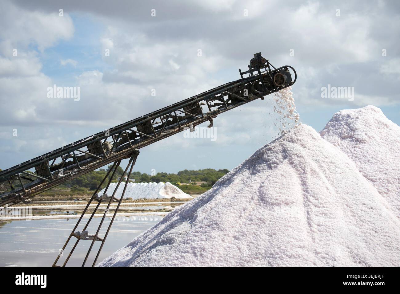 Sea salt production. The conveyor belt with salt Stock Photo - Alamy
