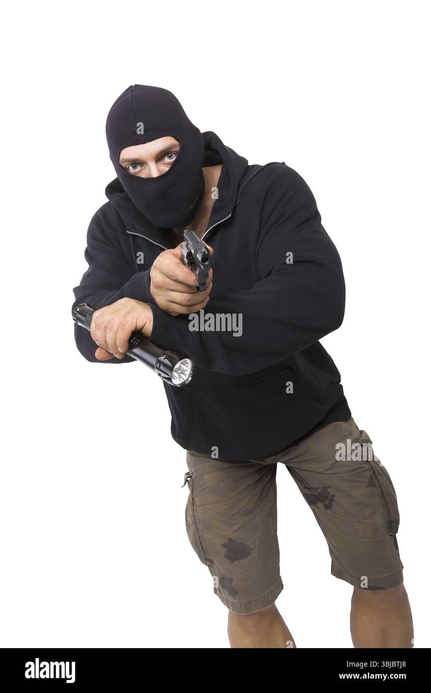 Man in black mask and black cloth holding flashlight and gun isolated ...