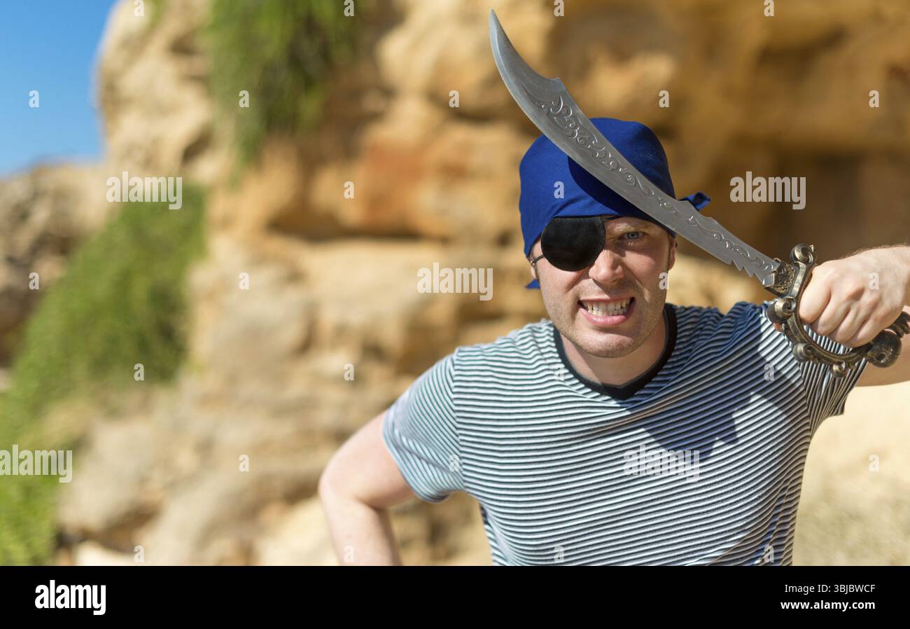 Angry male pirate with sword. Place for your text Stock Photo - Alamy