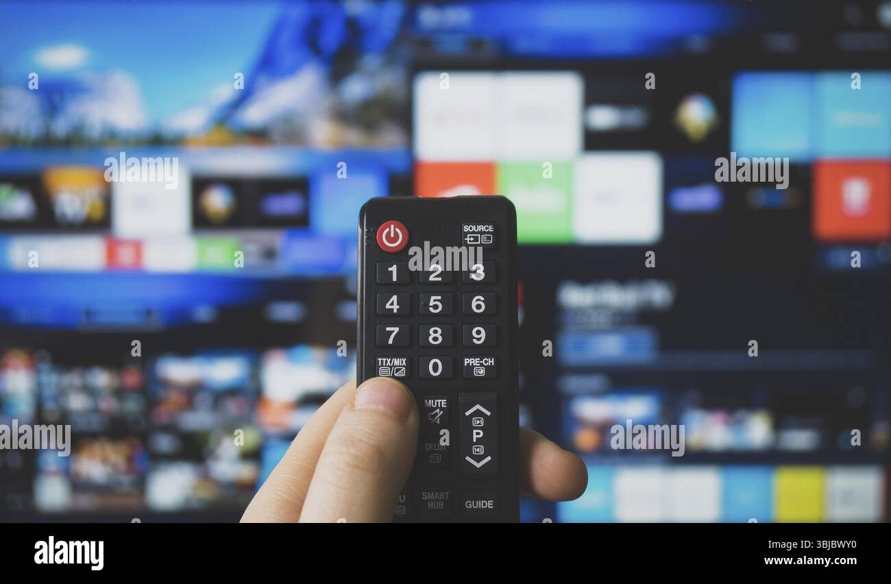 Hand holding tv remote smart hi-res stock photography and images - Alamy