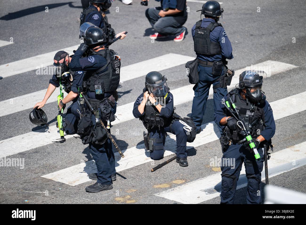 Los Angeles, USA. 14th June, 2025. Police officers don gas masks at a ...