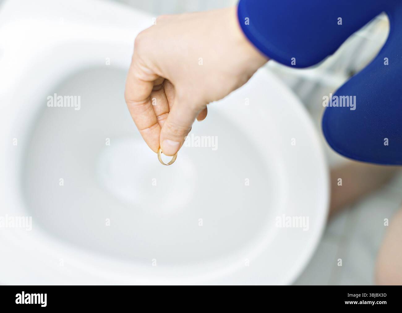 Divorce concept. Woman throwing her wedding ring in the toilet Stock ...